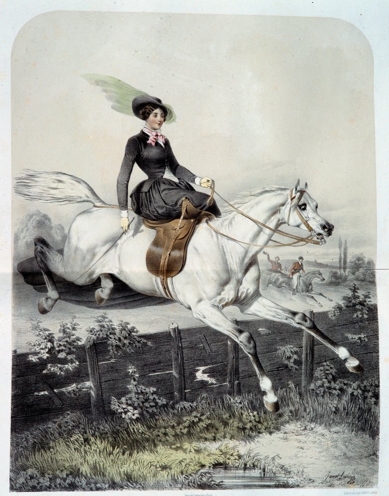 Un joven jinete en la amazona saltando una barrera